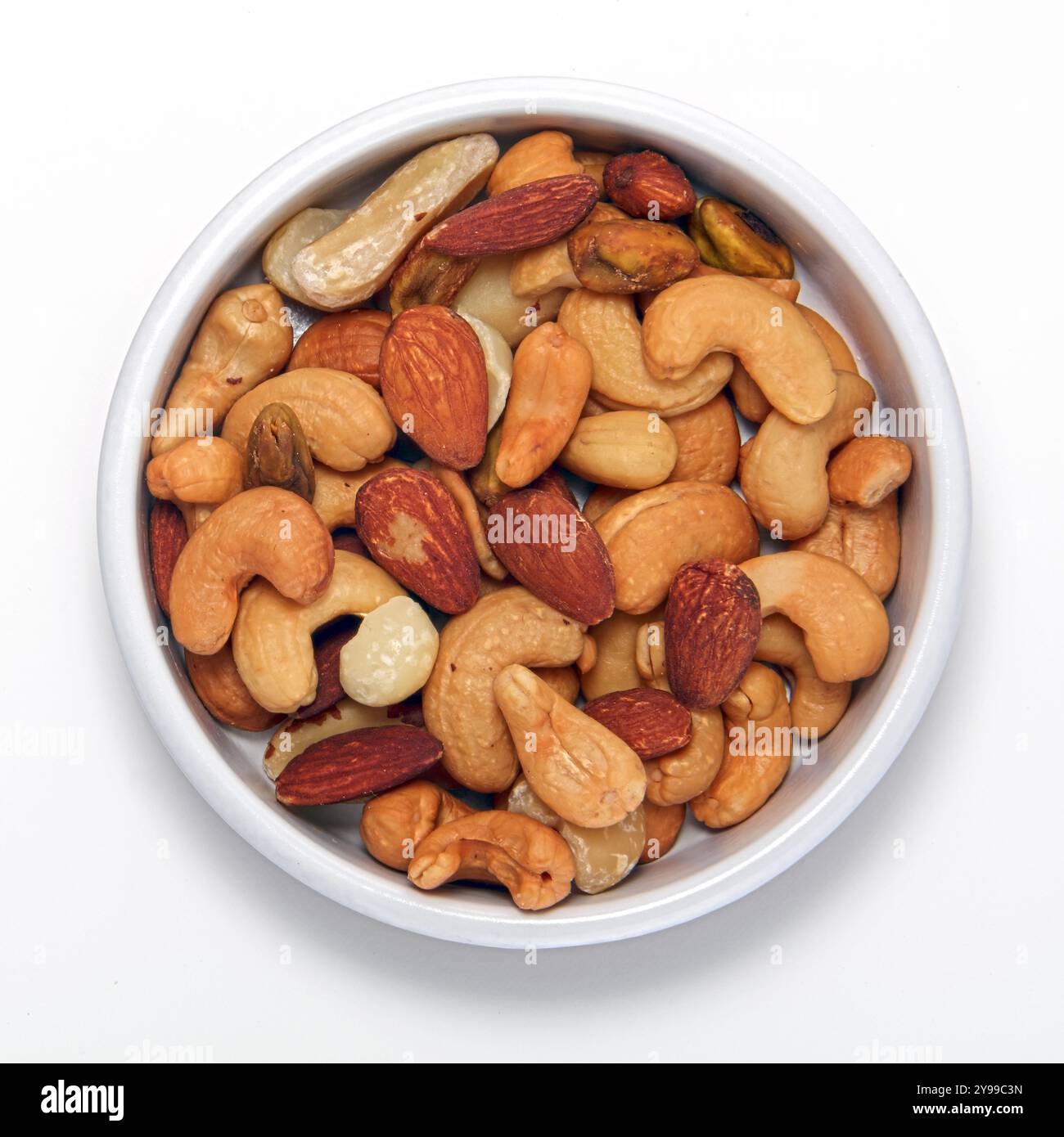 Mixed nuts in round container on a white background Stock Photo - Alamy