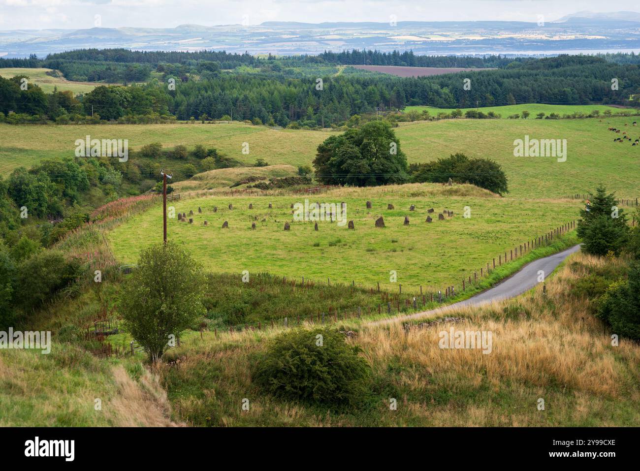A modern stone circle is seen from the top of the Knock Hill, located ...