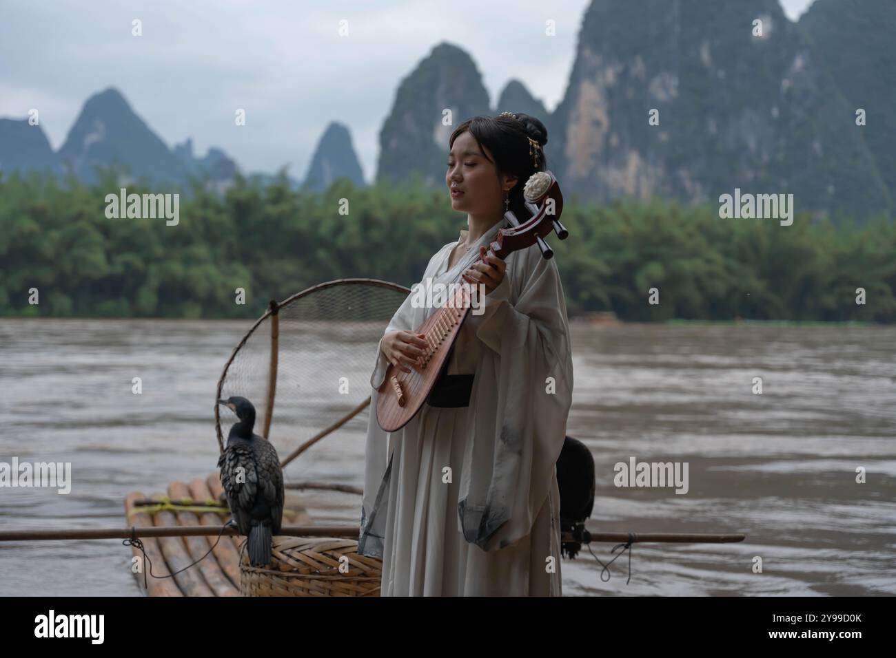 Hanfu girl with pipa instrument posing for a photographer on board of ...