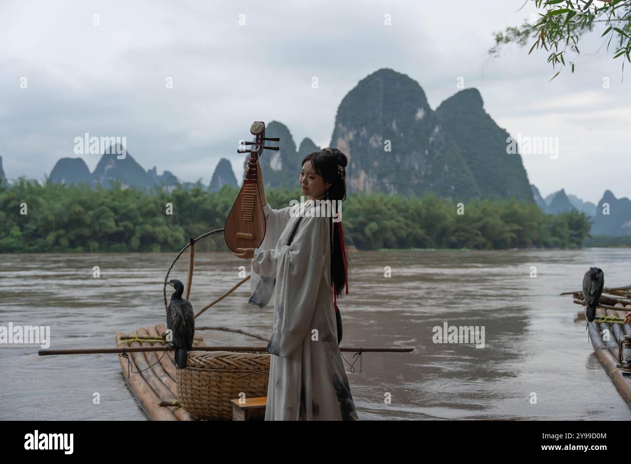 Hanfu girl with pipa instrument posing for a photographer on board of ...