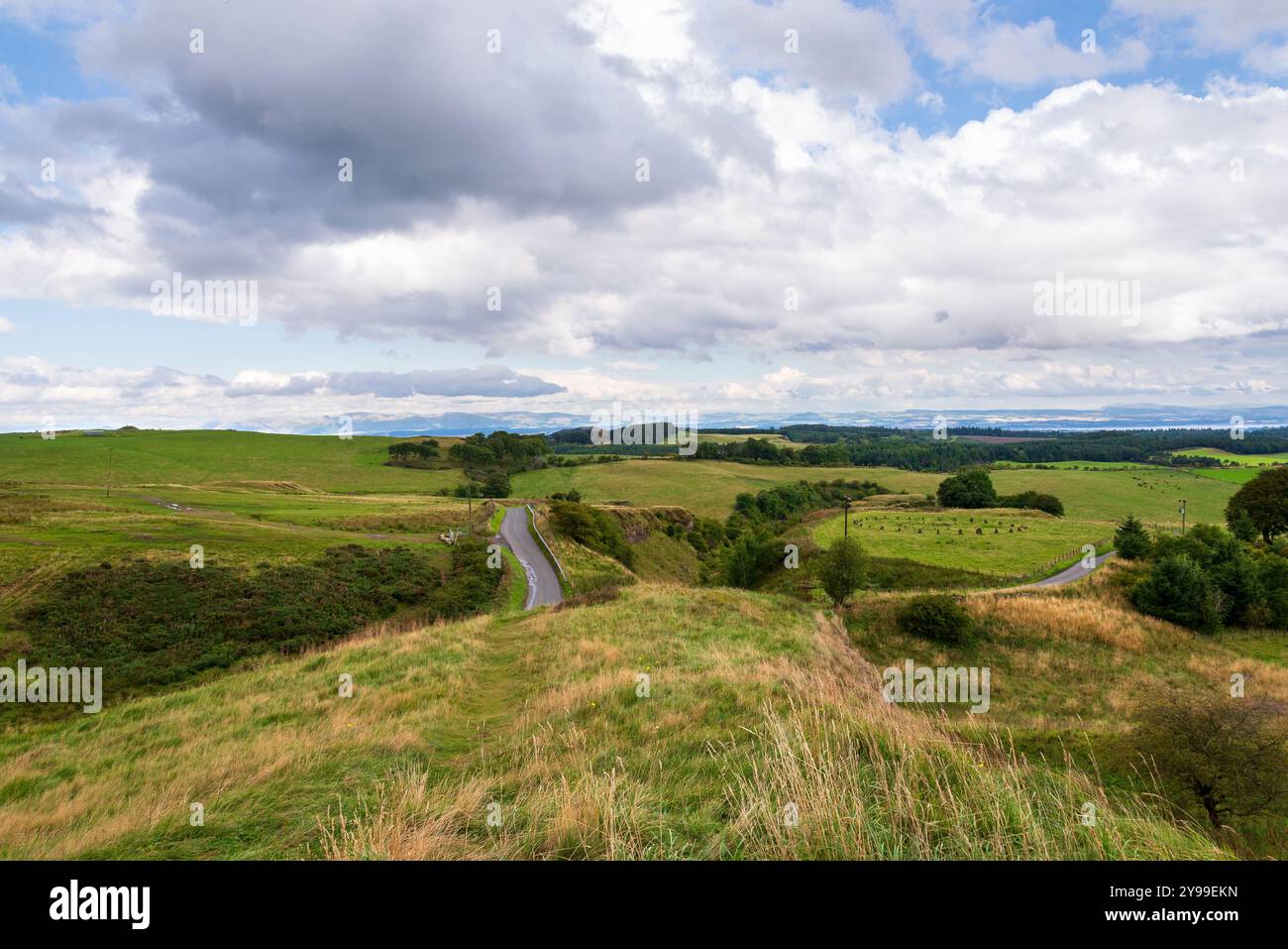 A narrow road passes through the green and bucolic Bathgate Hills in ...