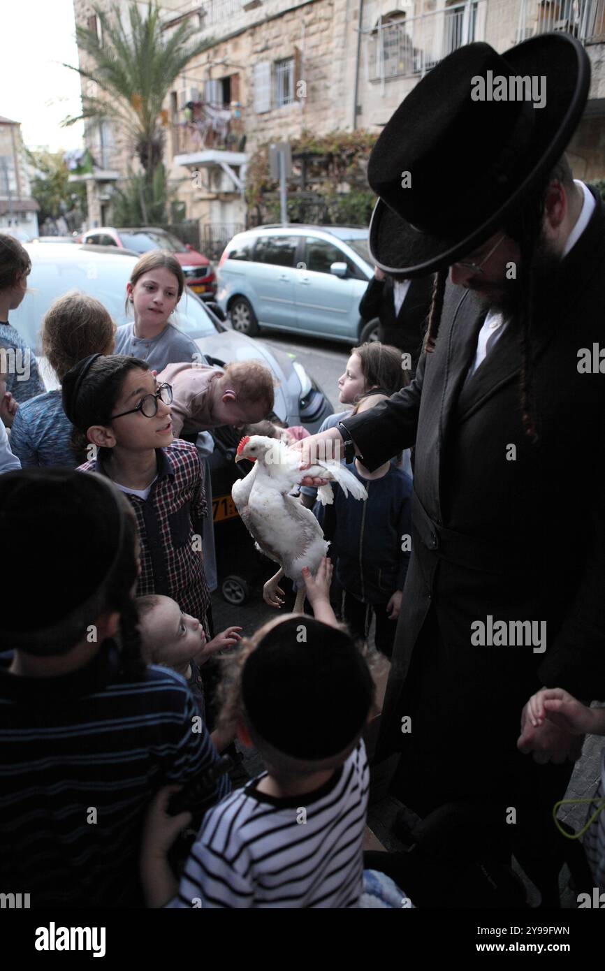 Ultra Orthodox man shows a rooster to kids & toddlers who look & touch ...
