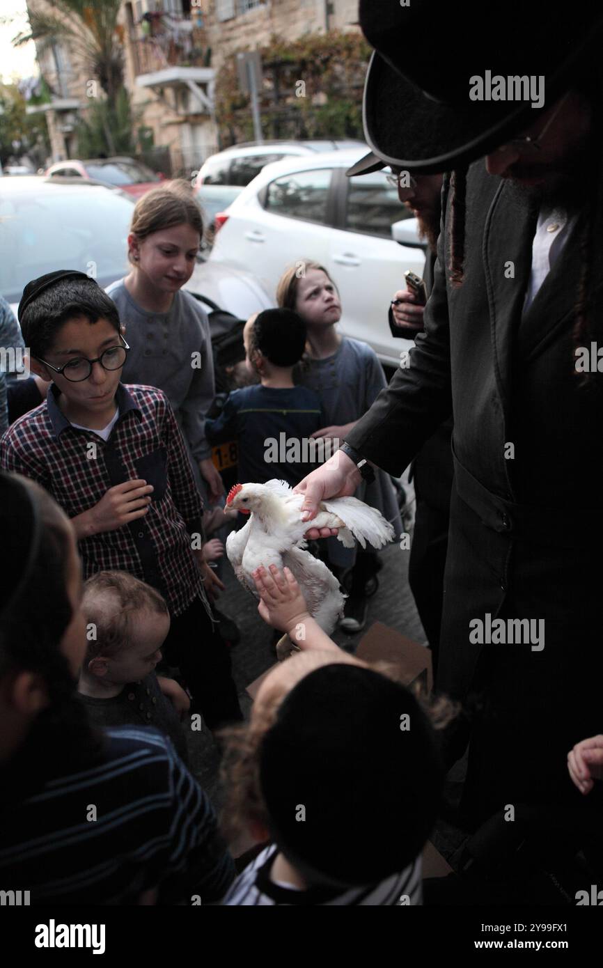 Ultra Orthodox man shows a rooster to kids & toddlers who look & touch ...
