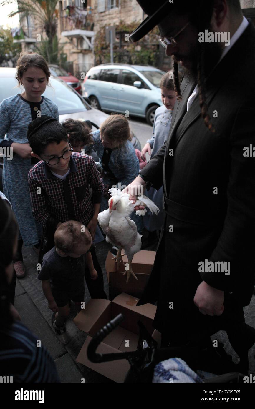 Ultra Orthodox man shows a rooster to kids & toddlers who look & touch ...