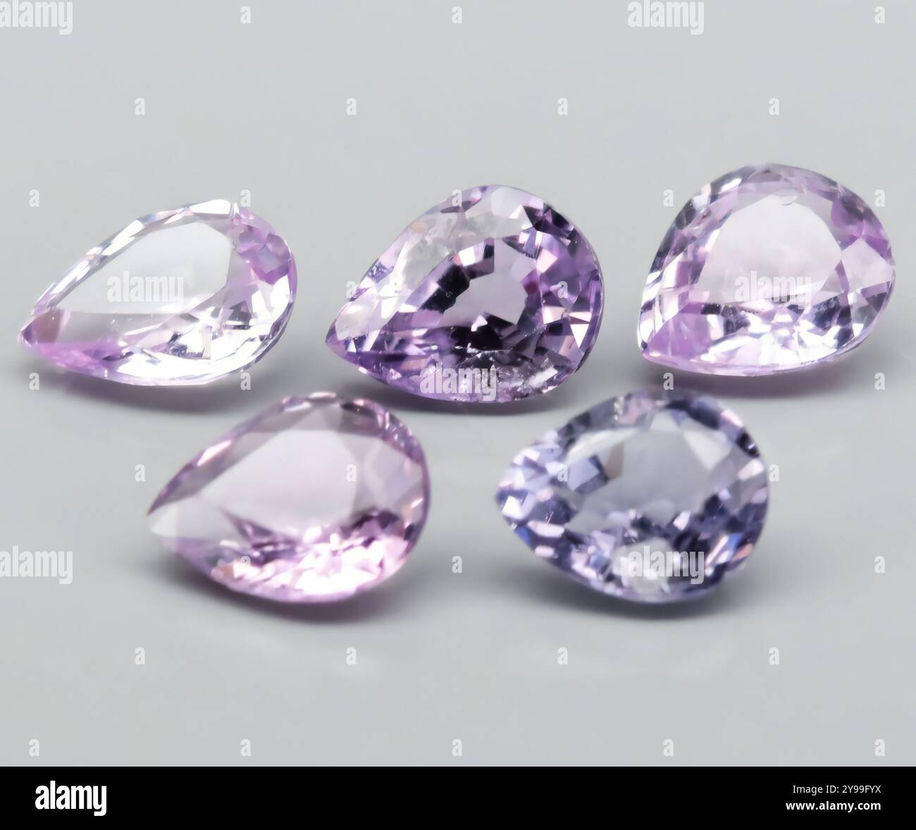 Exquisite Collection of Lustrous Pear Shaped Purple Gemstones Displayed ...