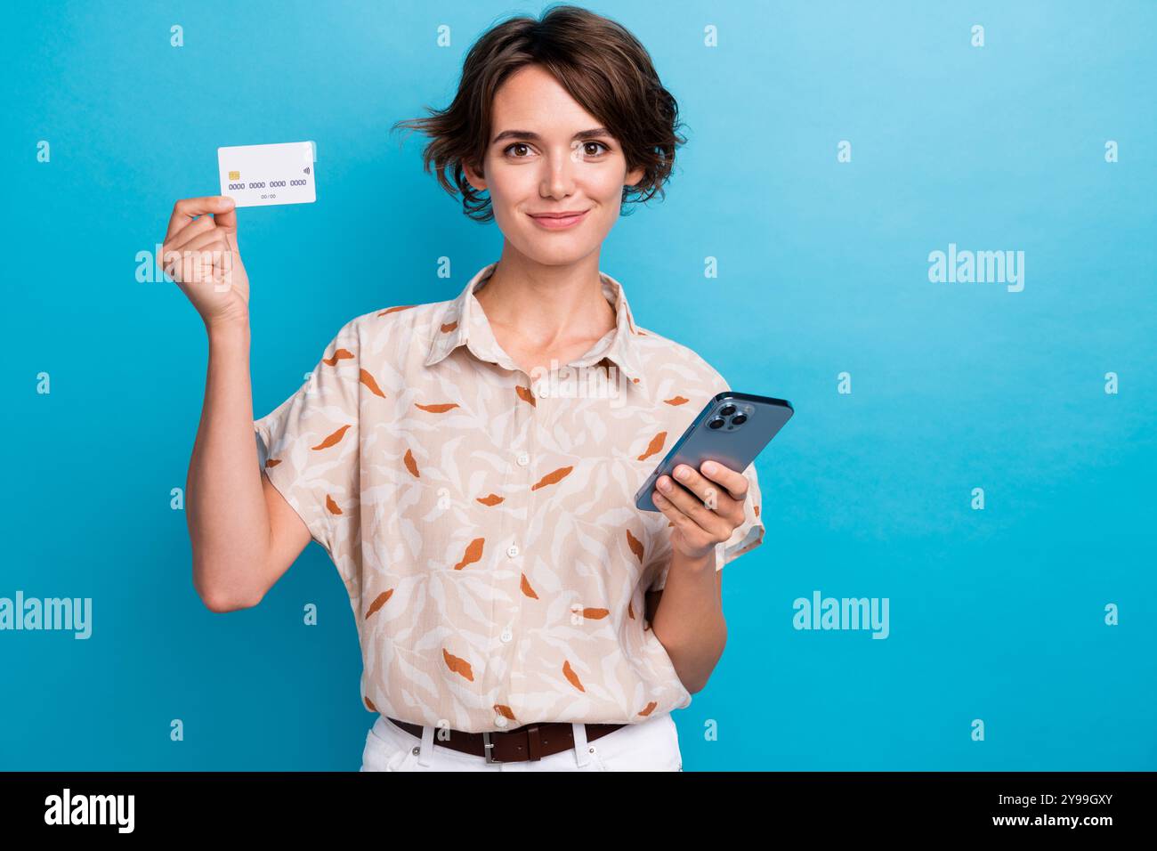 Portrait of pretty lady hold smart phone showing plastic debit card ...