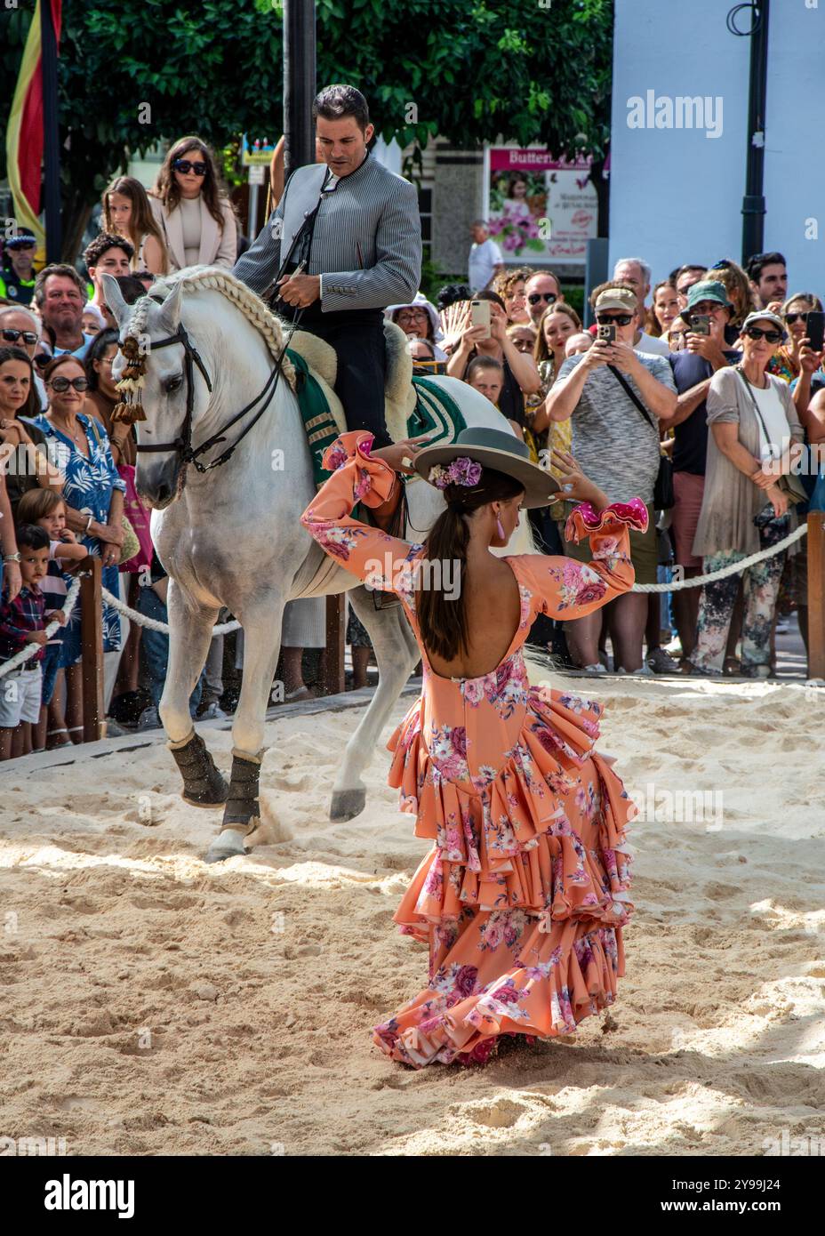 Fuengirola, Malaga, Spain. Rider and dancer in pink flamenco dress and ...