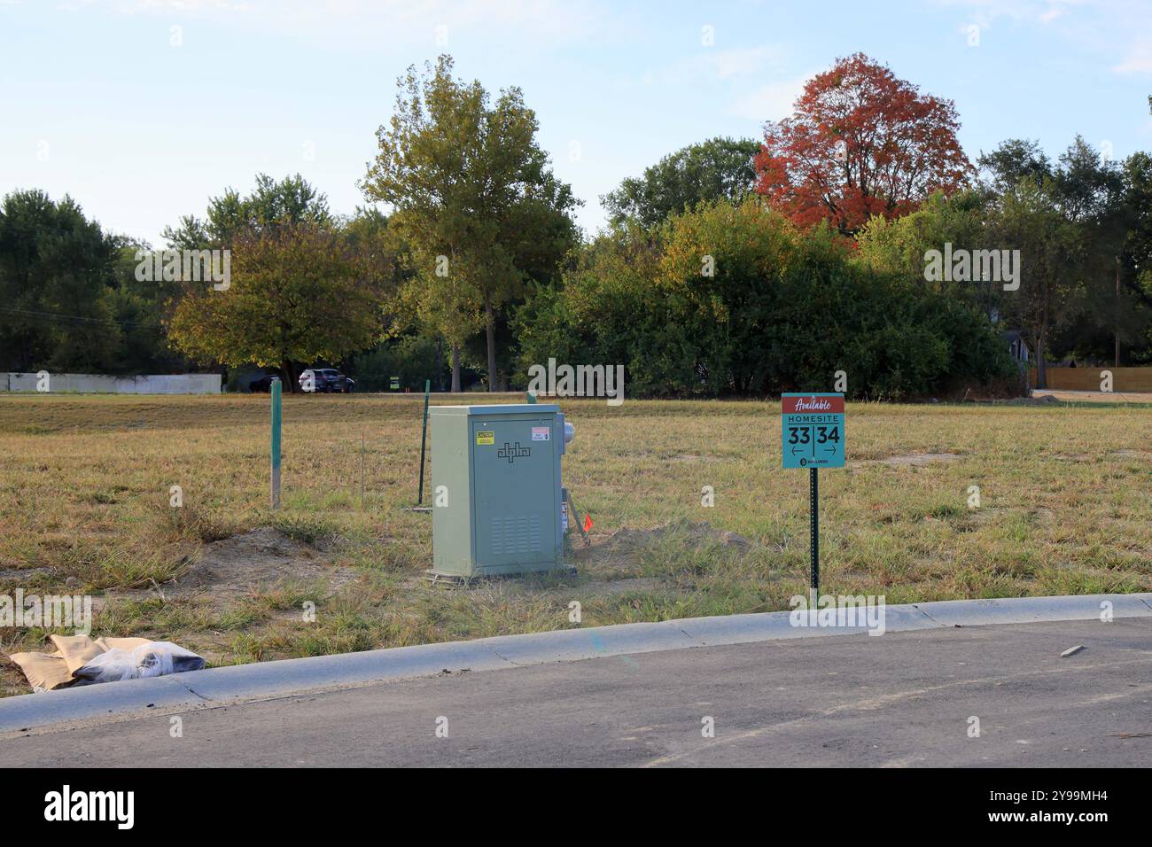 Empty, new residential housing building plot with existing homes and ...