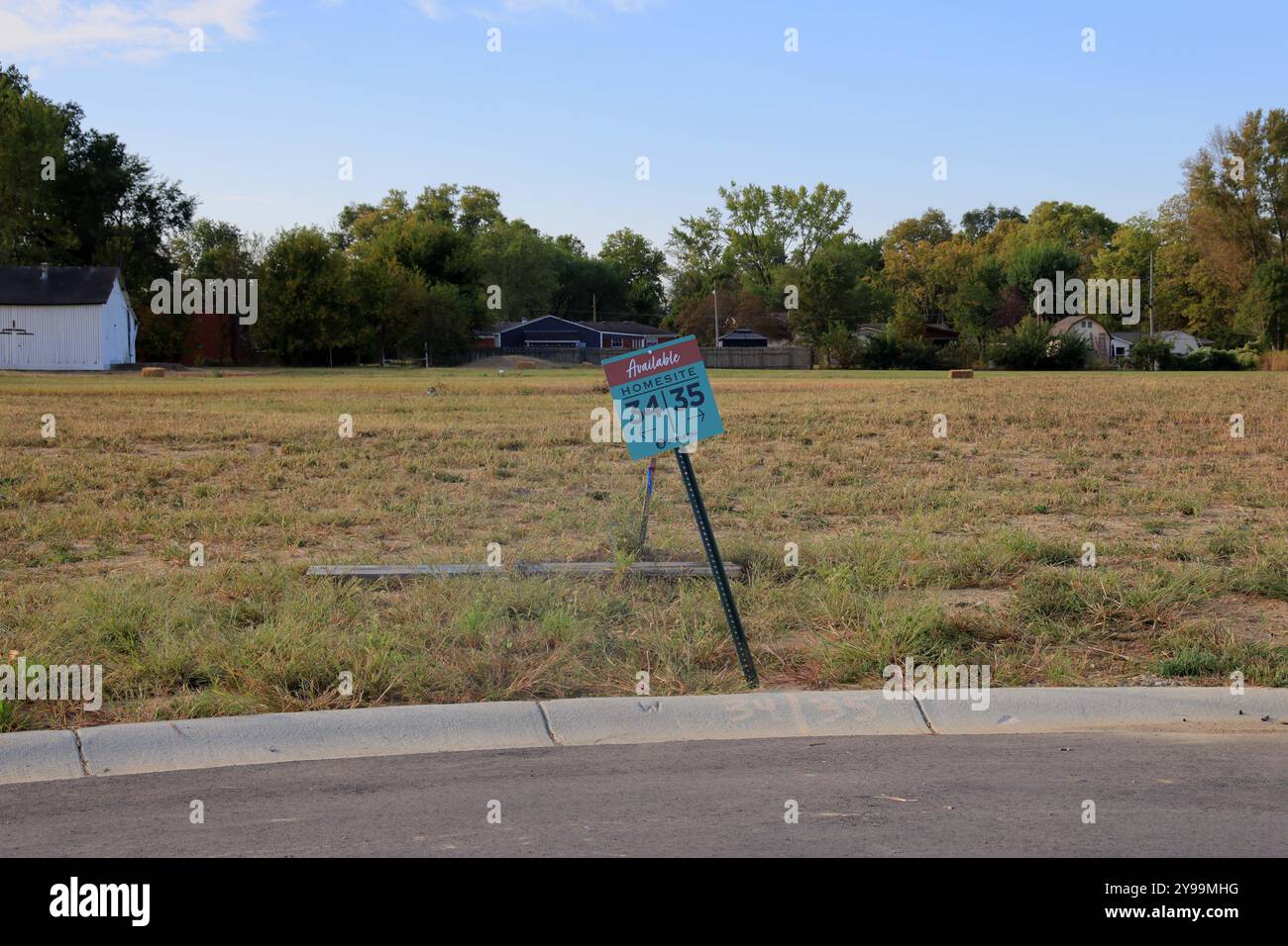 Empty, new residential housing building plot with existing homes and ...
