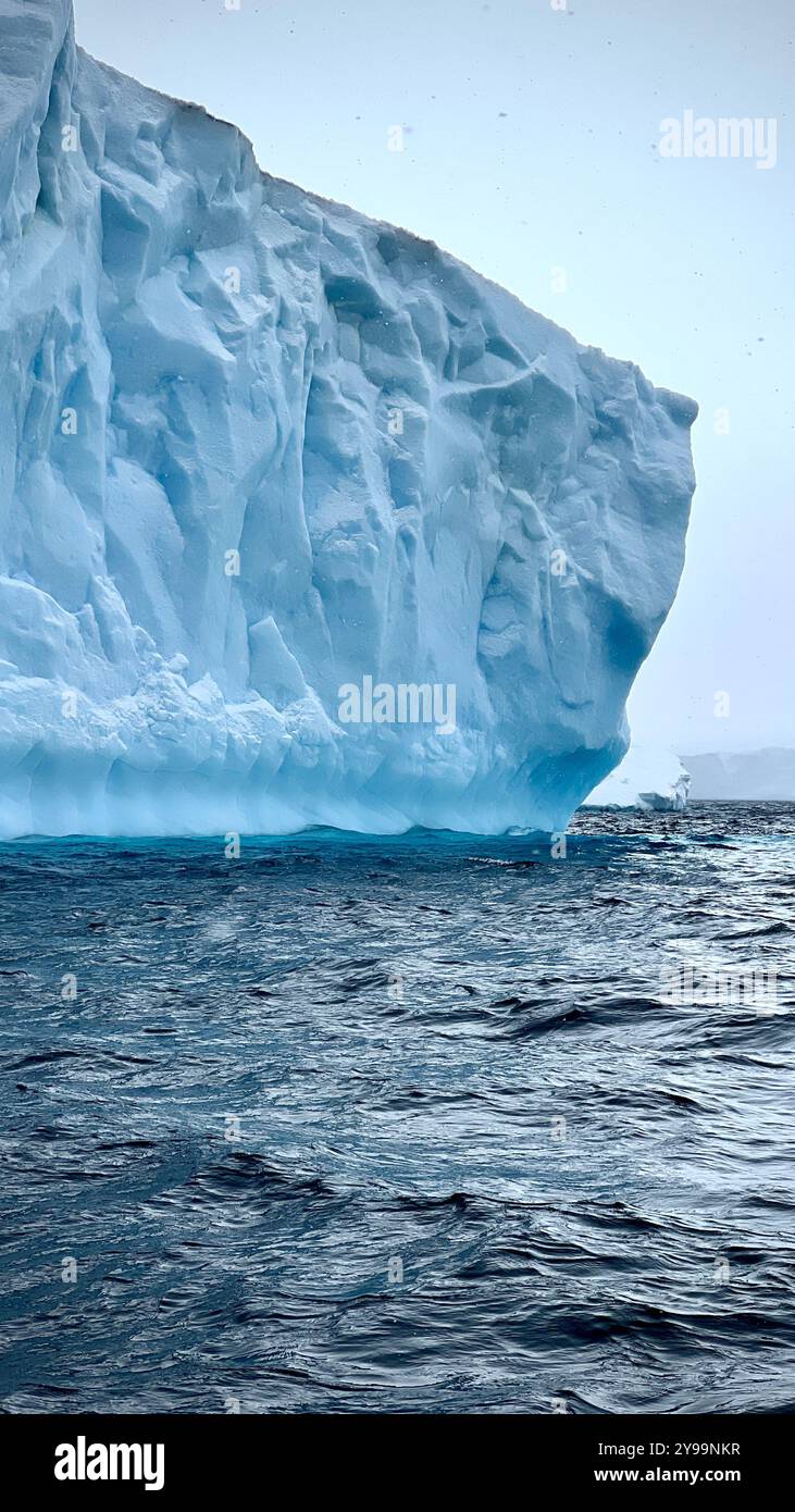 Close-up of a towering iceberg in the Southern Ocean, its massive blue ...