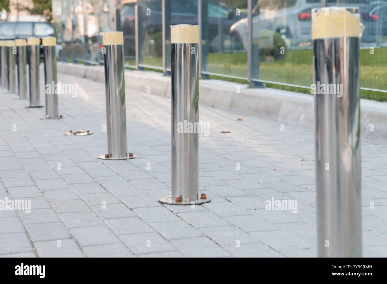 Urban Stainless Steel Bollards on Paved Pathway in Modern Landscape Design Stock Photo - Alamy