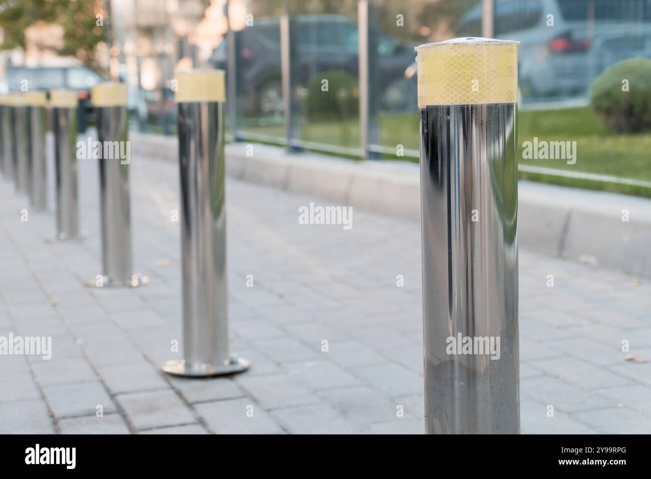 Polished Steel Bollards Lining a Modern Urban Pathway Stock Photo - Alamy