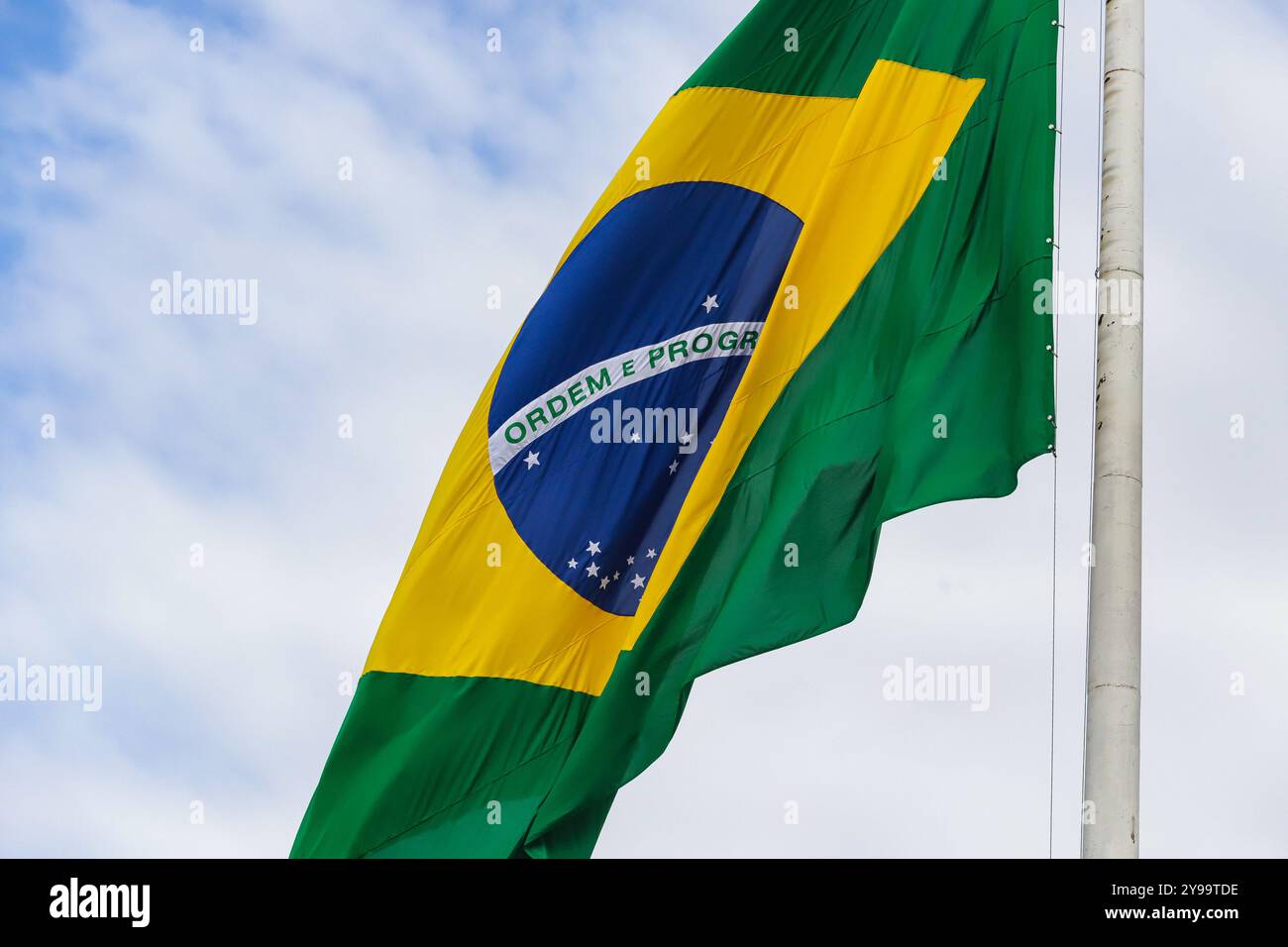 Flag of Brazil, country located in South America, on a blue sky between ...