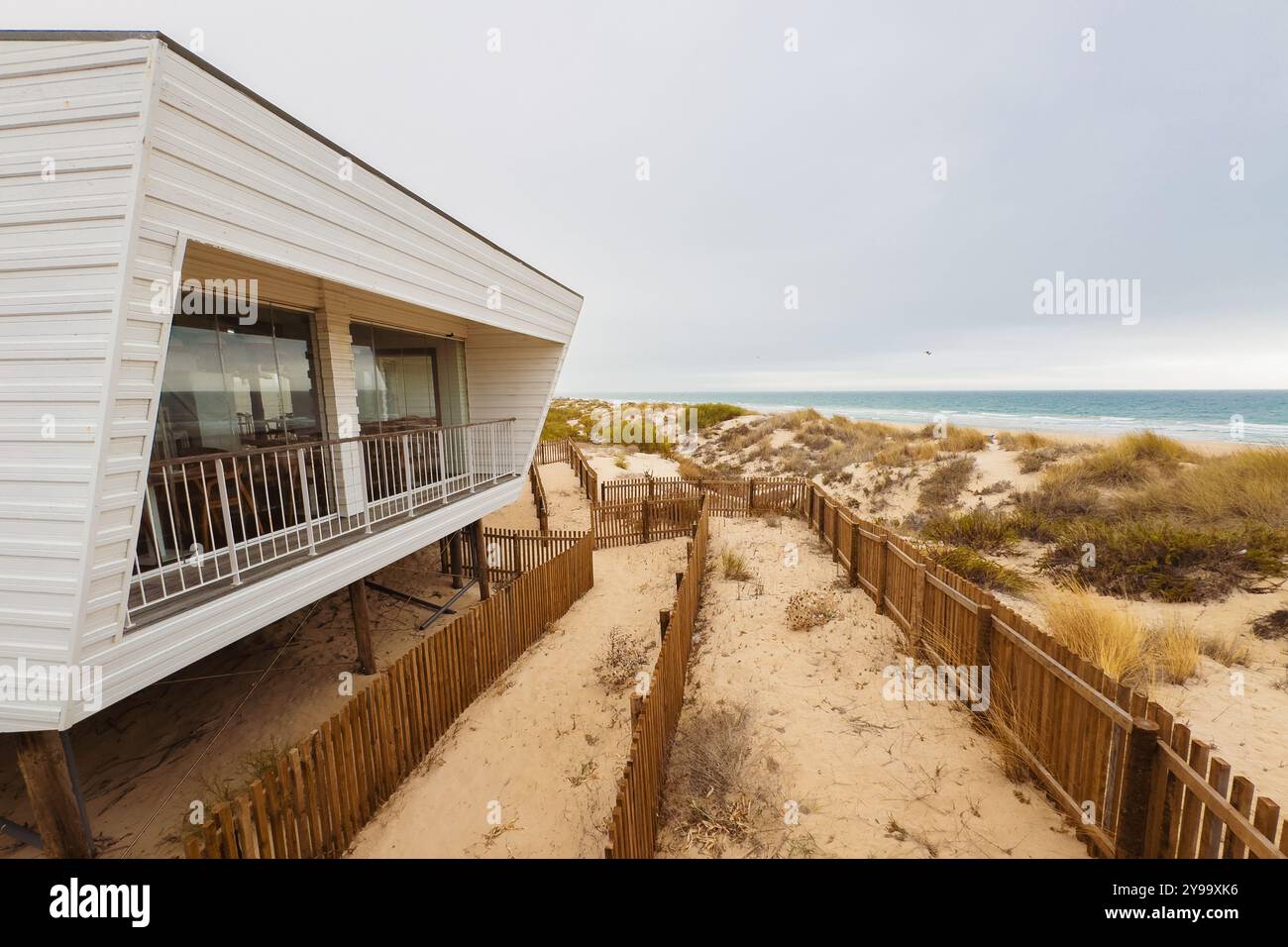 Modern beachfront restaurant on stilts overlooks sandy dunes and the ...