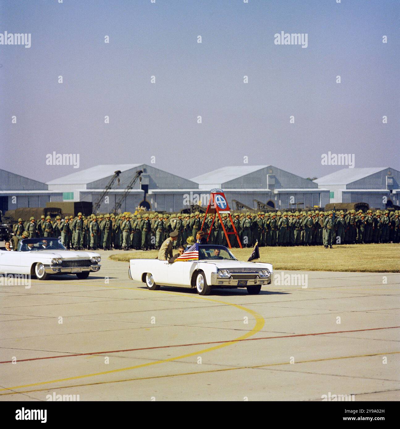 U.S. President John Kennedy riding in open convertible car past ...