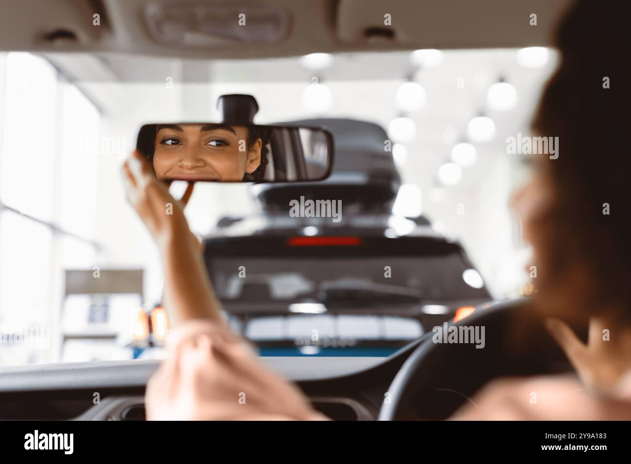 Girl Checking Mirrors Sitting In Driver's Seat In Dealership Store ...