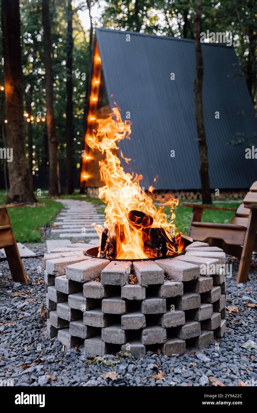 Outdoor campfire with warm flames in a cozy forest setting, ideal for ...