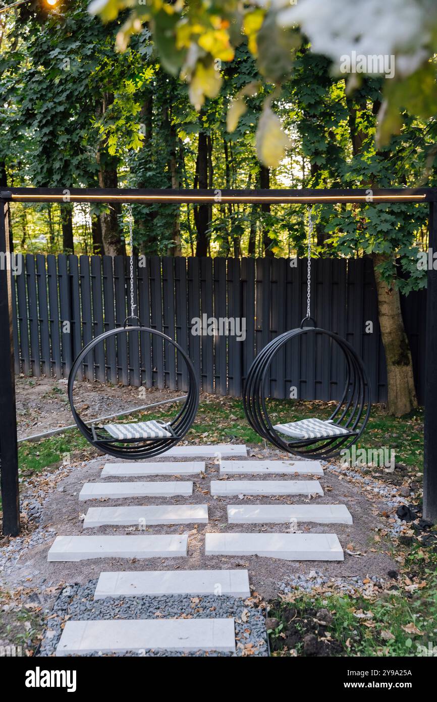 Modern hanging round swings hi-res stock photography and images - Alamy