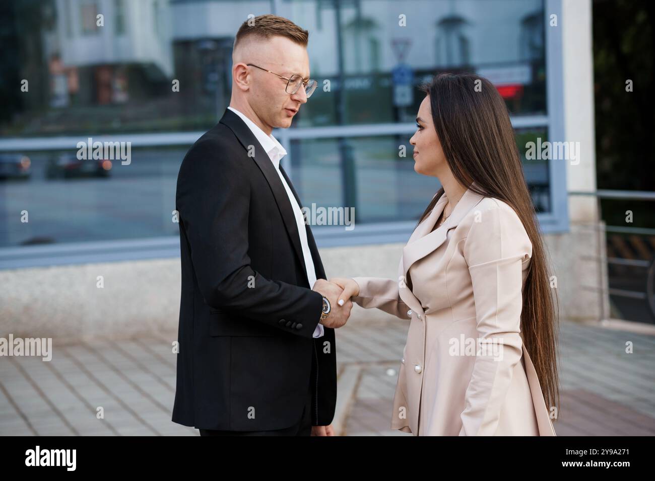 Elegant Business Encounter: A Professional Exchange Between Two Colleagues in Stylish Attire ...
