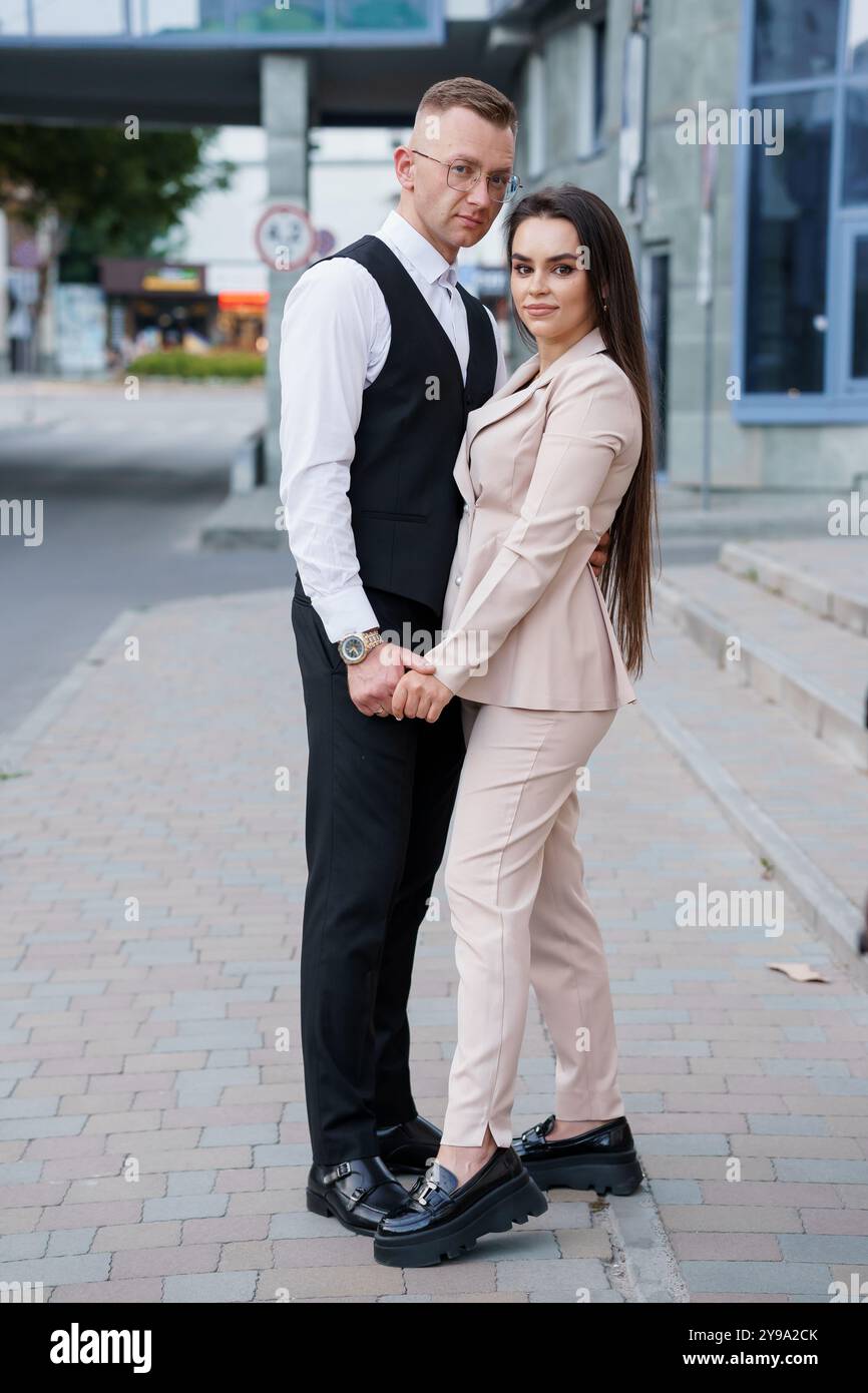Elegant Urban Couple Embracing in Modern Attire Stock Photo - Alamy