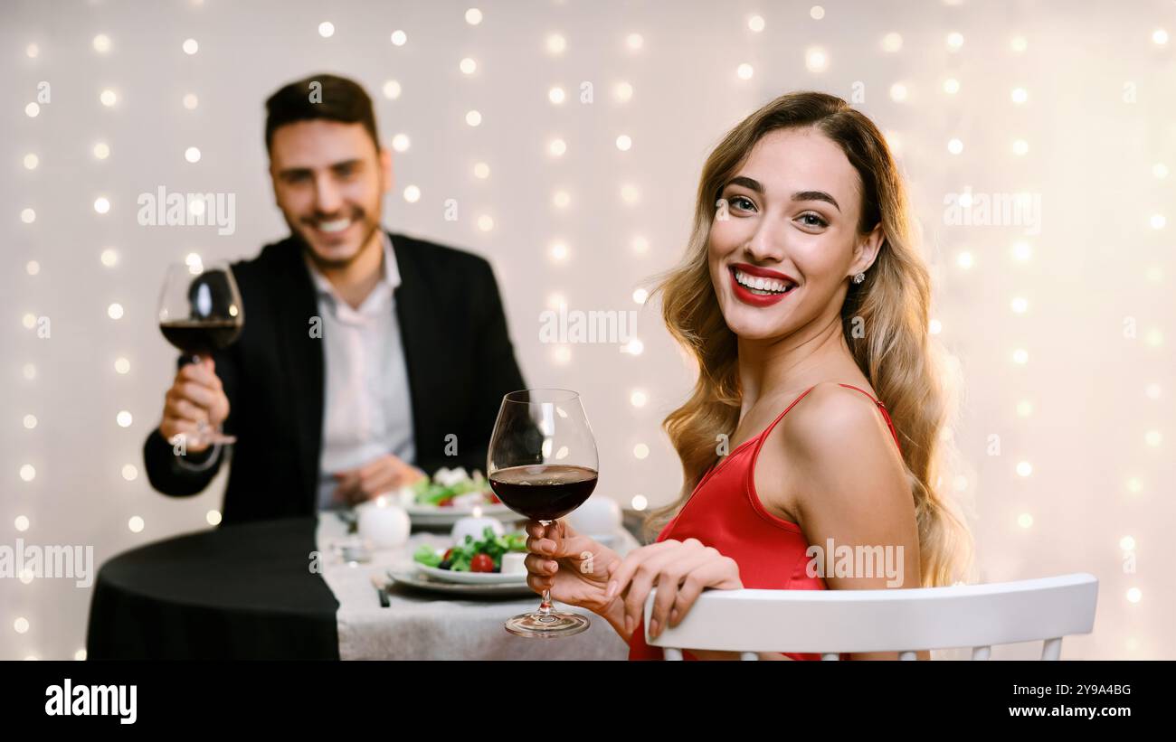Millennial couple having romantic dinner together, posing to camera in ...