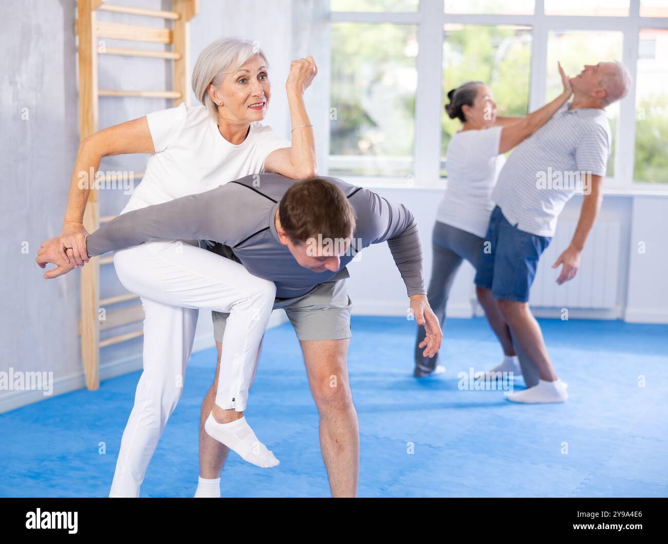 Old woman practicing self-defense techniques in pairs Stock Photo - Alamy
