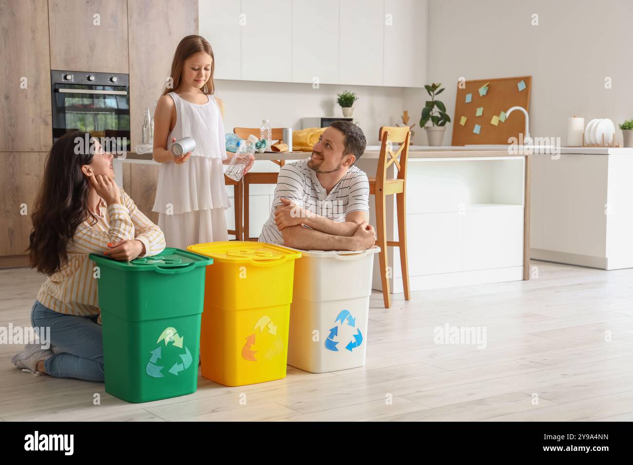 Family with recycle trash bins in kitchen Stock Photo - Alamy