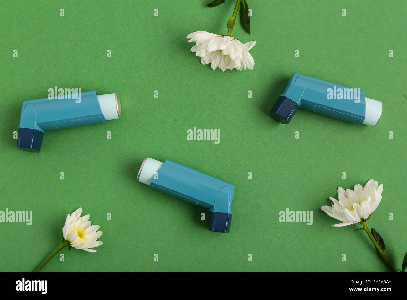 Modern inhalers and chrysanthemum flowers on green background Stock ...
