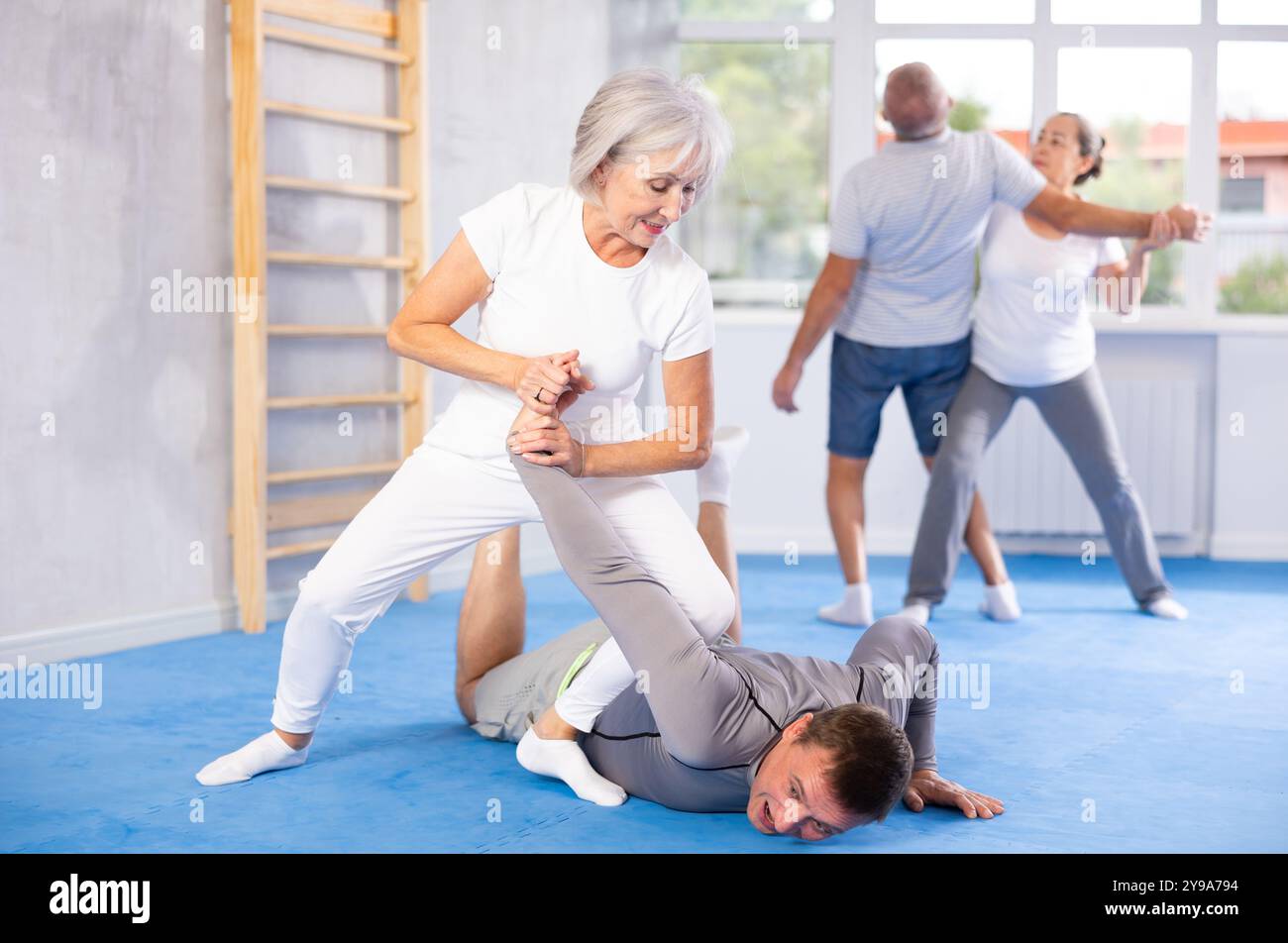 Old woman twisting her opponent's arm during self-defense classes Stock ...