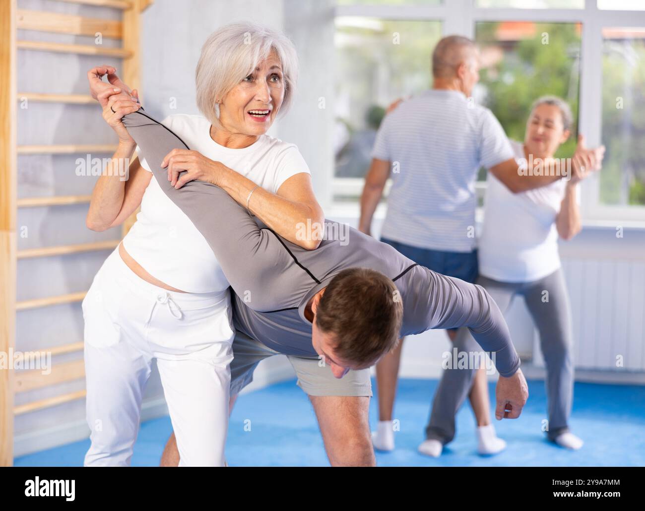 Old woman twisting her opponent's arm during self-defense classes Stock ...