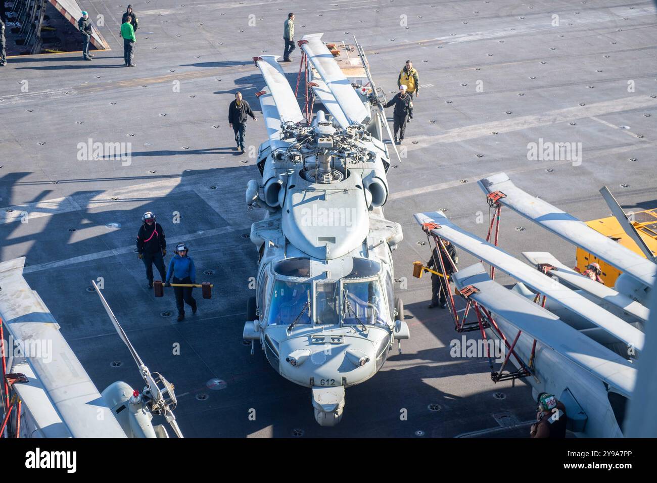 PACIFIC OCEAN (Oct. 7, 2024) U.S. Navy Sailors move an MH-60S Sea Hawk ...