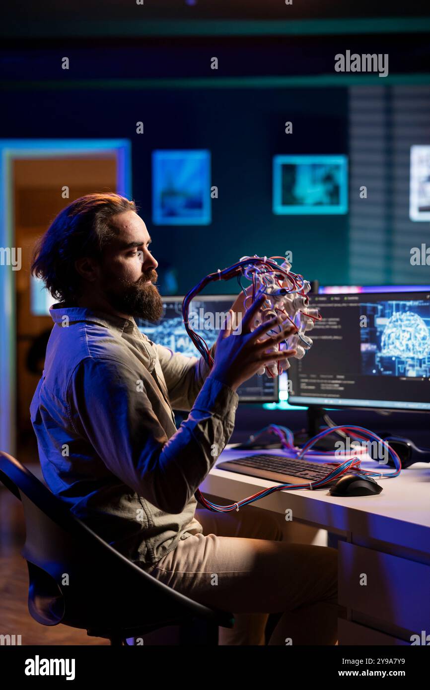 Scientist specializing in artificial intelligence putting EEG headset ...