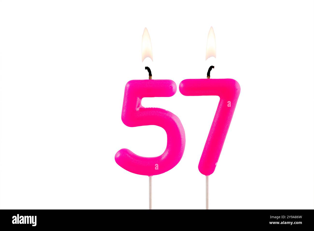 Pink number 57 birthday candle on white background Stock Photo - Alamy