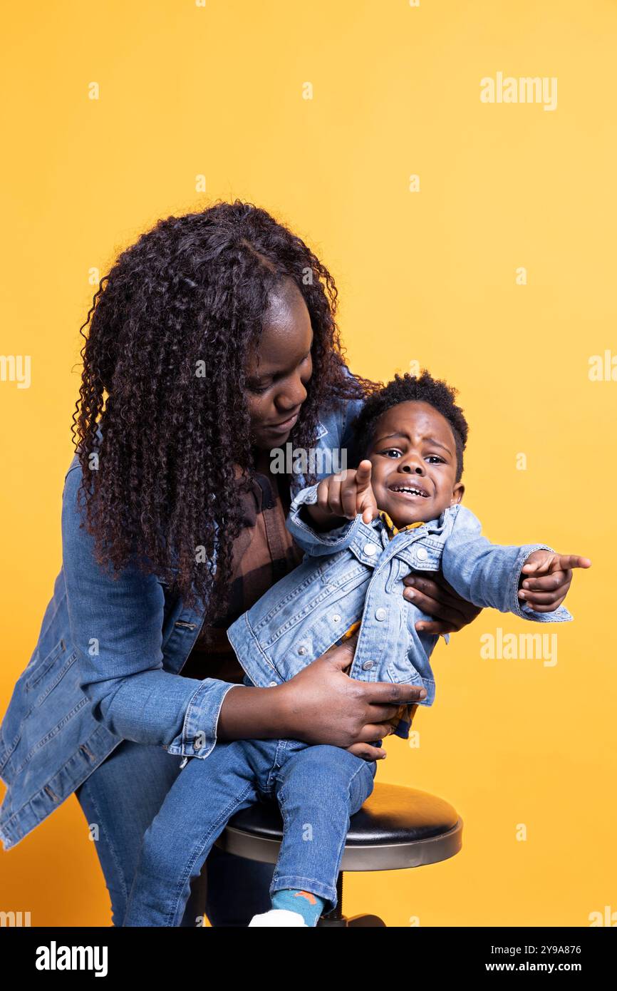 Nervous anxious little baby boy starts crying in studio, his mother is ...