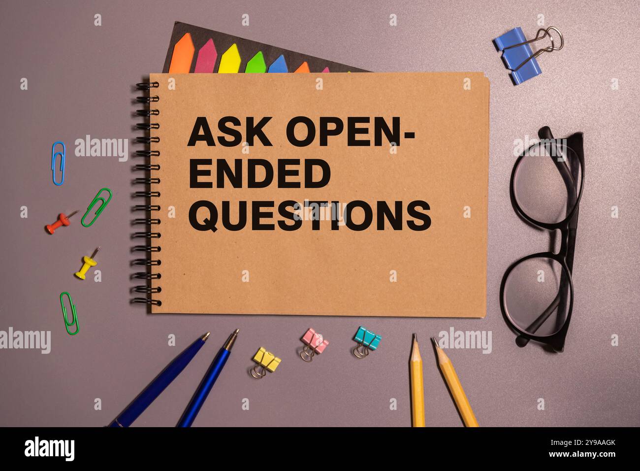 Ask Open-Ended Questions written on a notebook page, pencil on the left ...