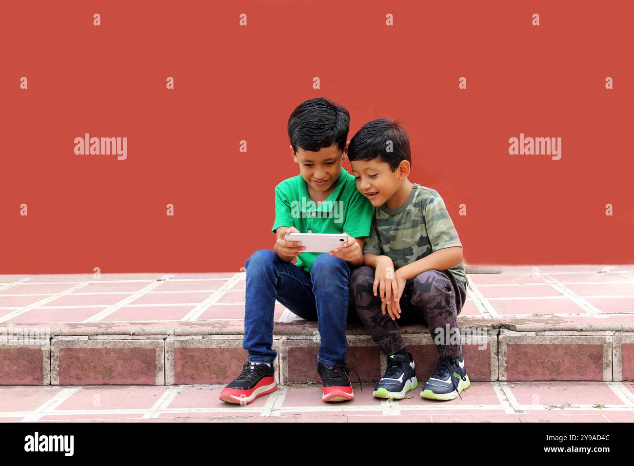 Two dark-haired Latino children who are brothers or friends who live in ...