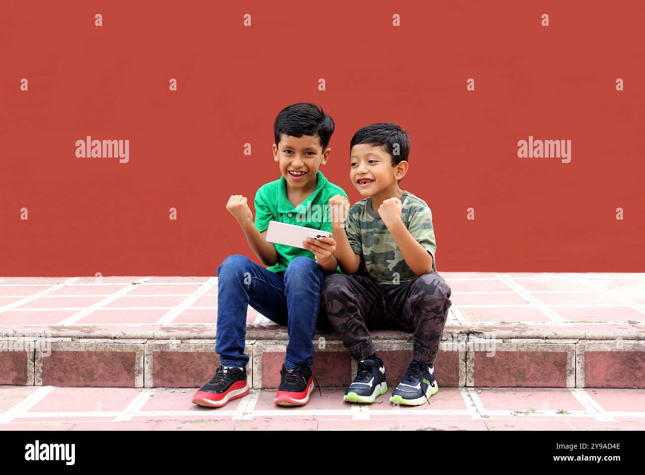 Two dark-haired Latino children who are brothers or friends who live in ...