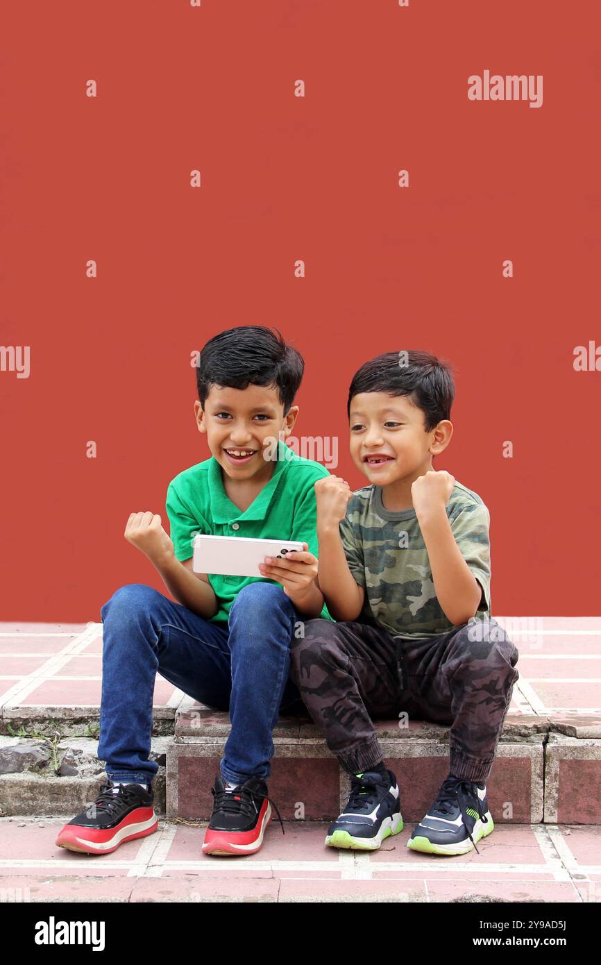 Two dark-haired Latino children who are brothers or friends who live in ...