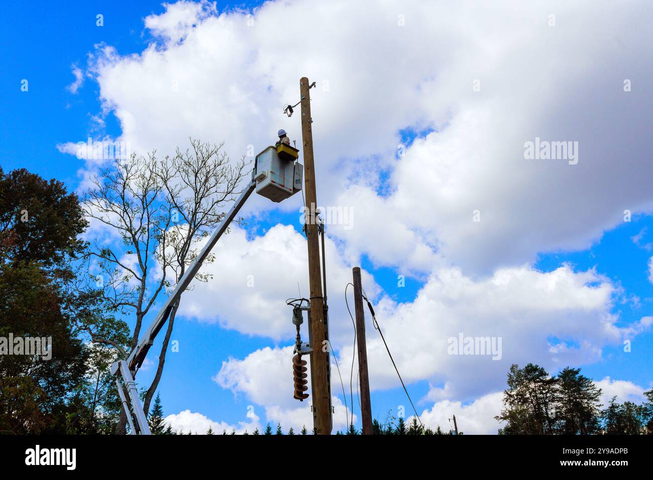 Electrician working repair at power line poles electric power system ...