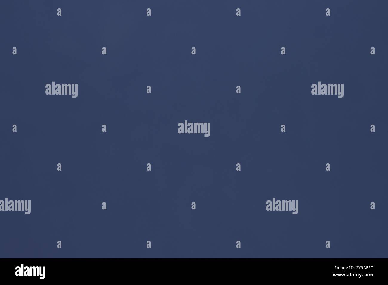 This paper background in a uniform navy blue color with slight ...