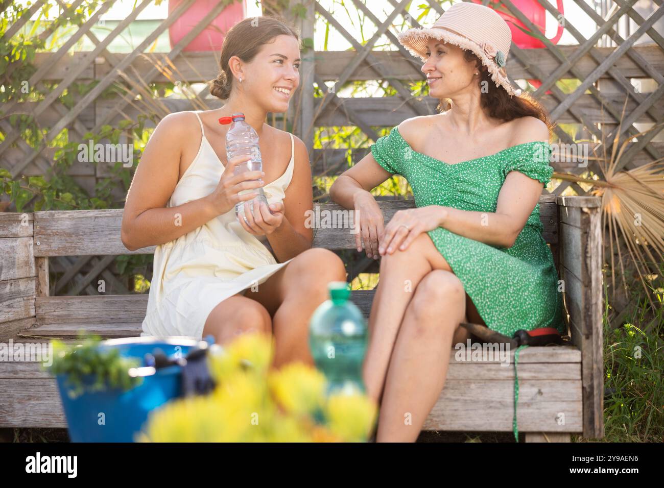 Conversation between two adult friends who are sitting on bench in ...