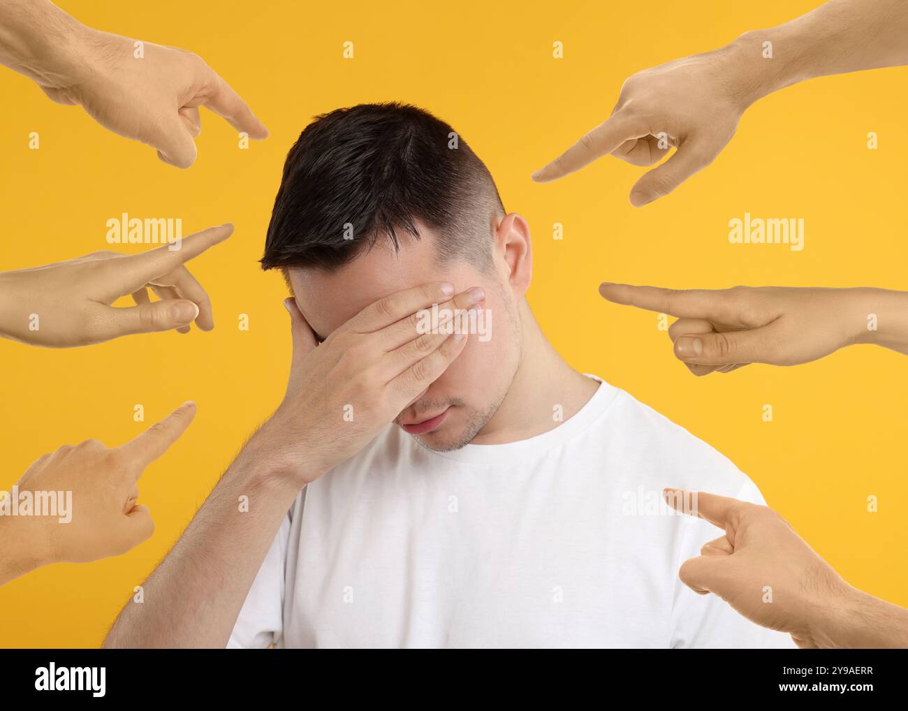 People pointing at embarrassed man on orange background Stock Photo - Alamy