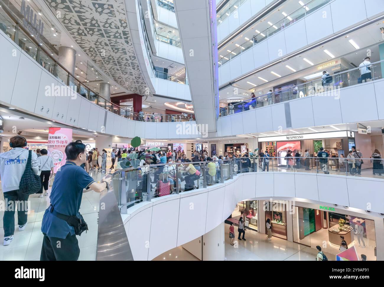 Hong Kong, China, October 08, 2024: A bustling shopping mall with a modern, minimalist design ...