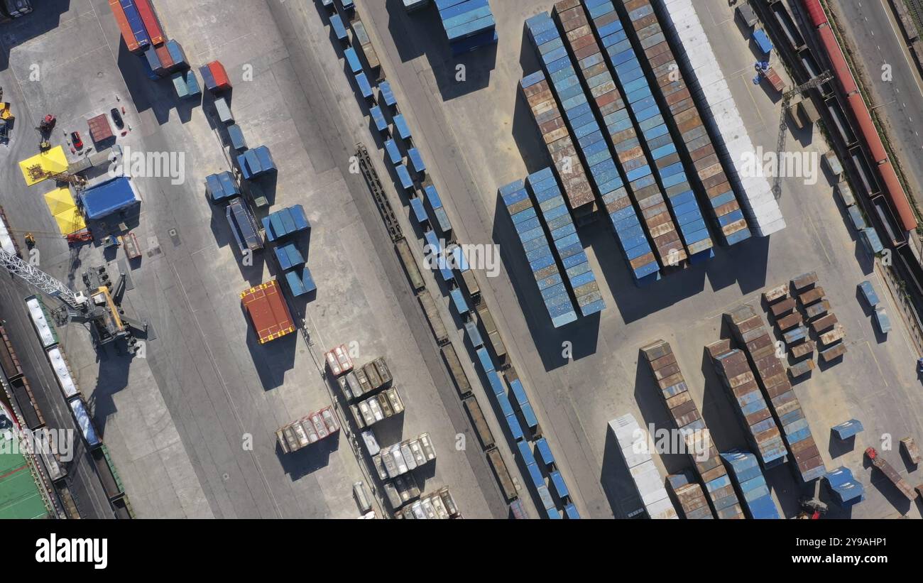 Aerial top view of cargo container terminal with railway, business ...