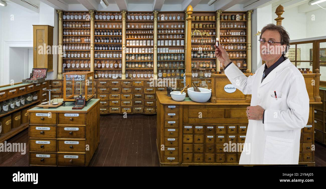 Historic pharmacy with pharmacist and bottle in hand Stock Photo - Alamy