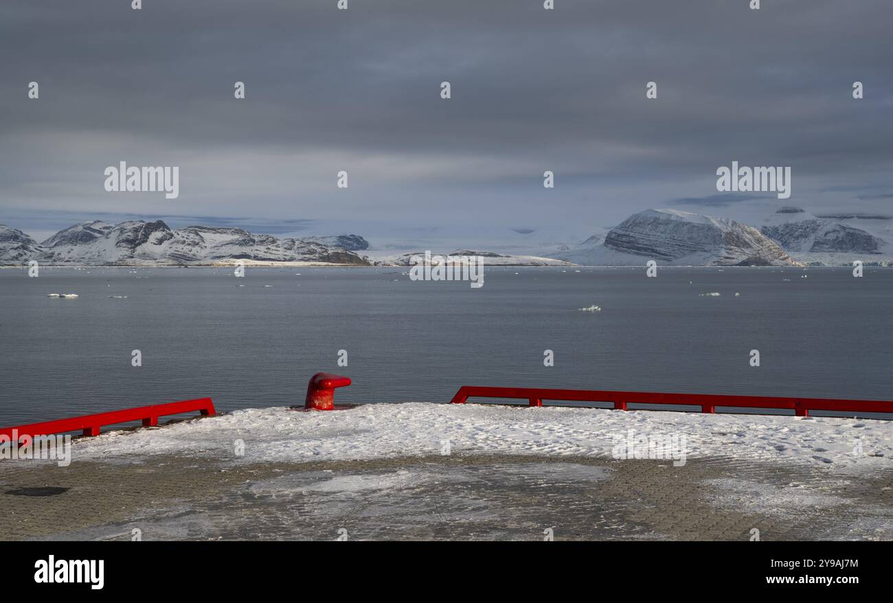 Red bollard and harbour boundary, harbour area, Ny-Alesund, Kongsfjord ...