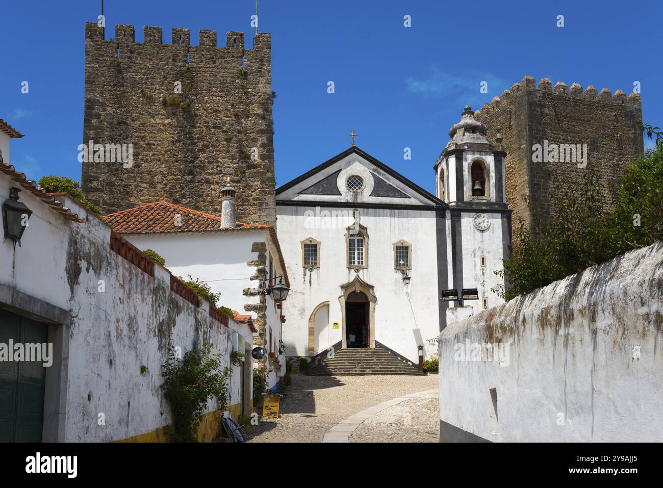 Medieval setting with castle walls and small chapel, church Igreja de ...