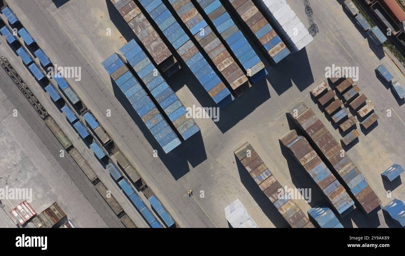 Aerial top view of cargo container terminal with railway, business ...