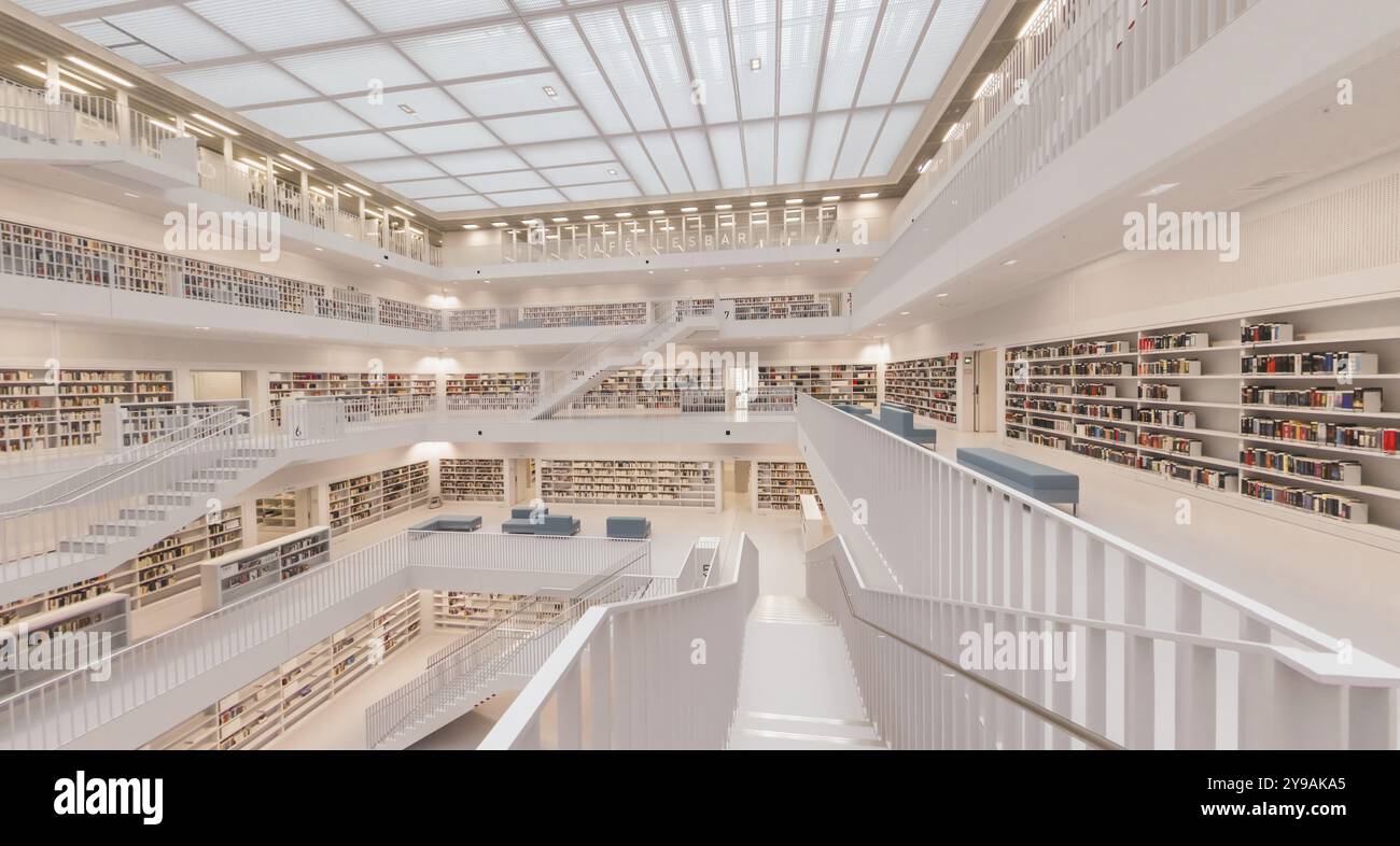 Modern, bright library with open staircases and many bookshelves in a ...