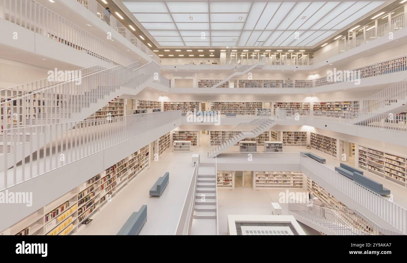 Modern, bright library with open staircases and many bookshelves in a ...